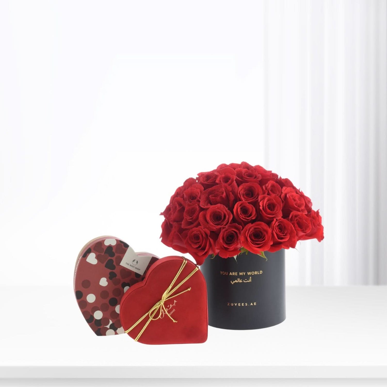 50 Roses in Red Aura with Body Shop & Bateel Dates | ZUVEES – Zuvees.ae